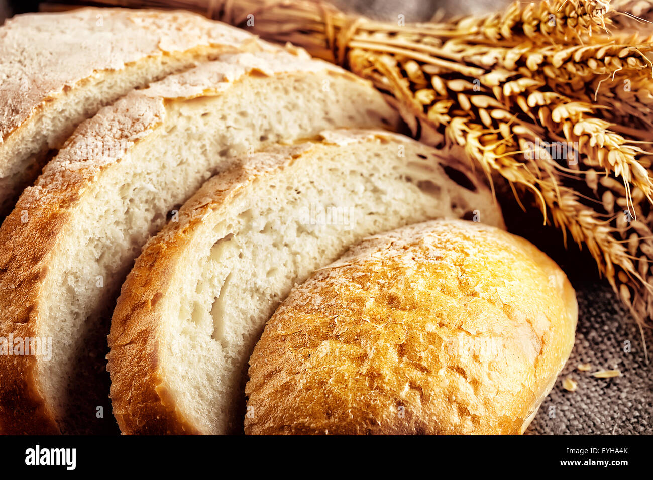 Loaf sliced white bread with ears wheat with a blurred background Stock ...