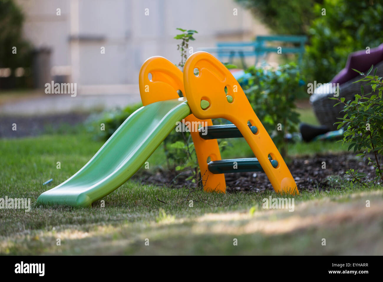 Children slides in the garden Stock Photo - Alamy
