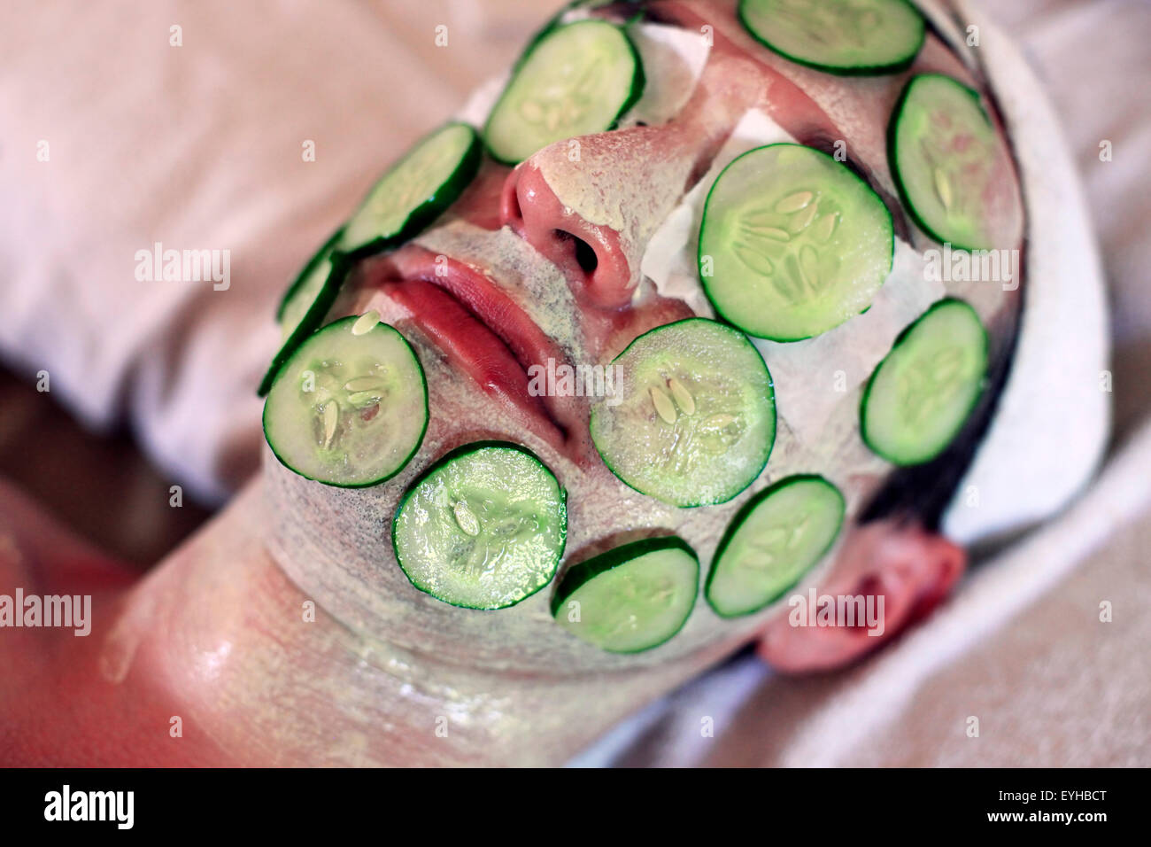 Mask from fresh cucumbers on face man Stock Photo - Alamy