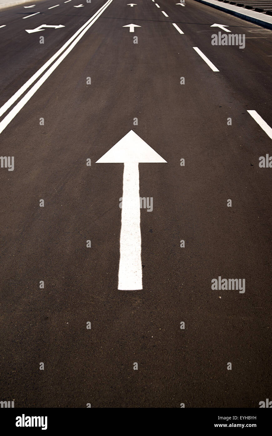 Road markings in the form of arrows on the asphalt road in the city ...