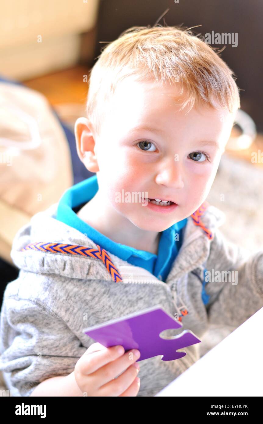Happy kids playing puzzles hi-res stock photography and images - Alamy
