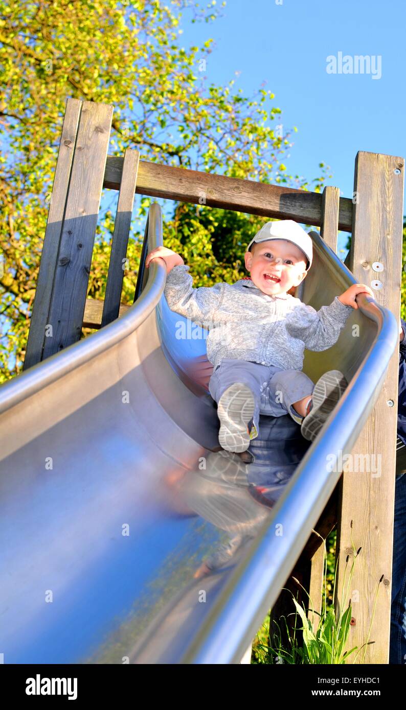 Portrait of a happy child on a slide Stock Photo - Alamy