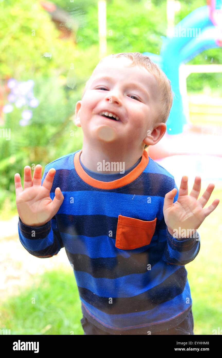 Portrait of a child pulling faces Stock Photo - Alamy