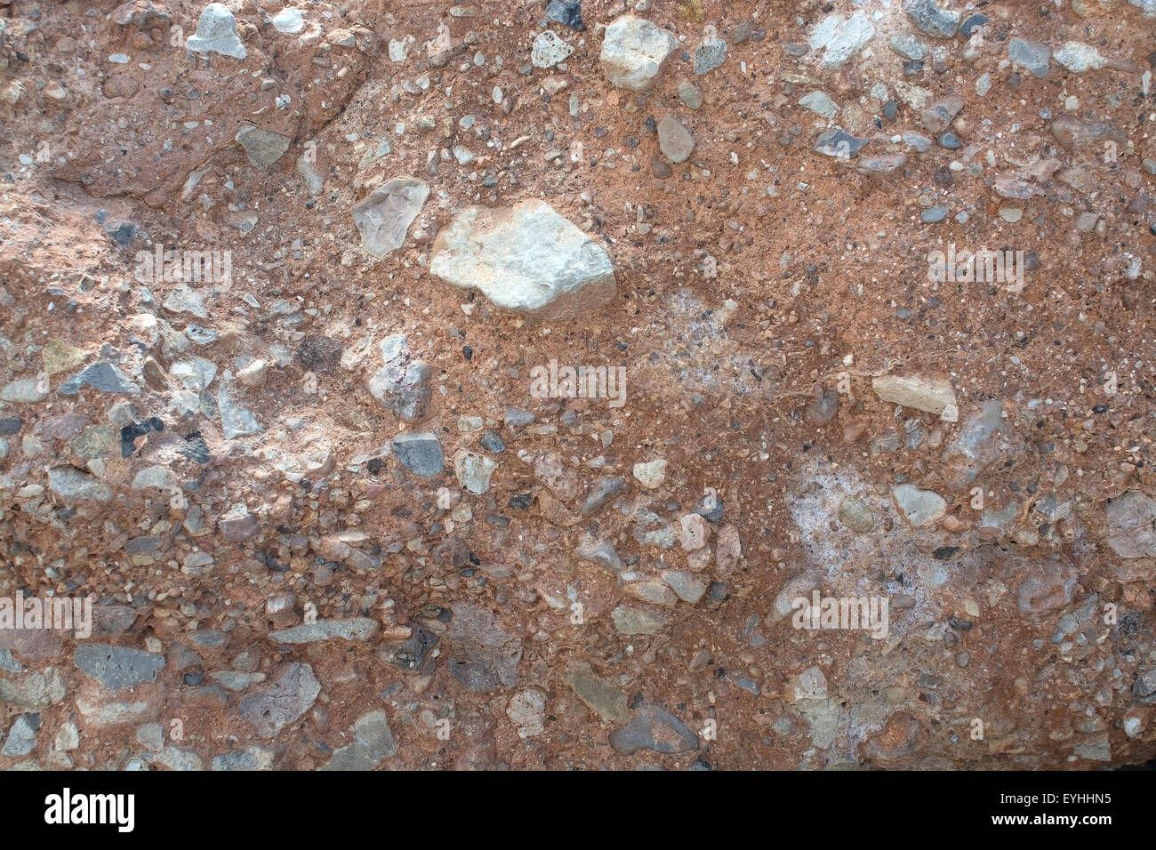 Red breccia or rough cast wall for background texture or copy space in ...