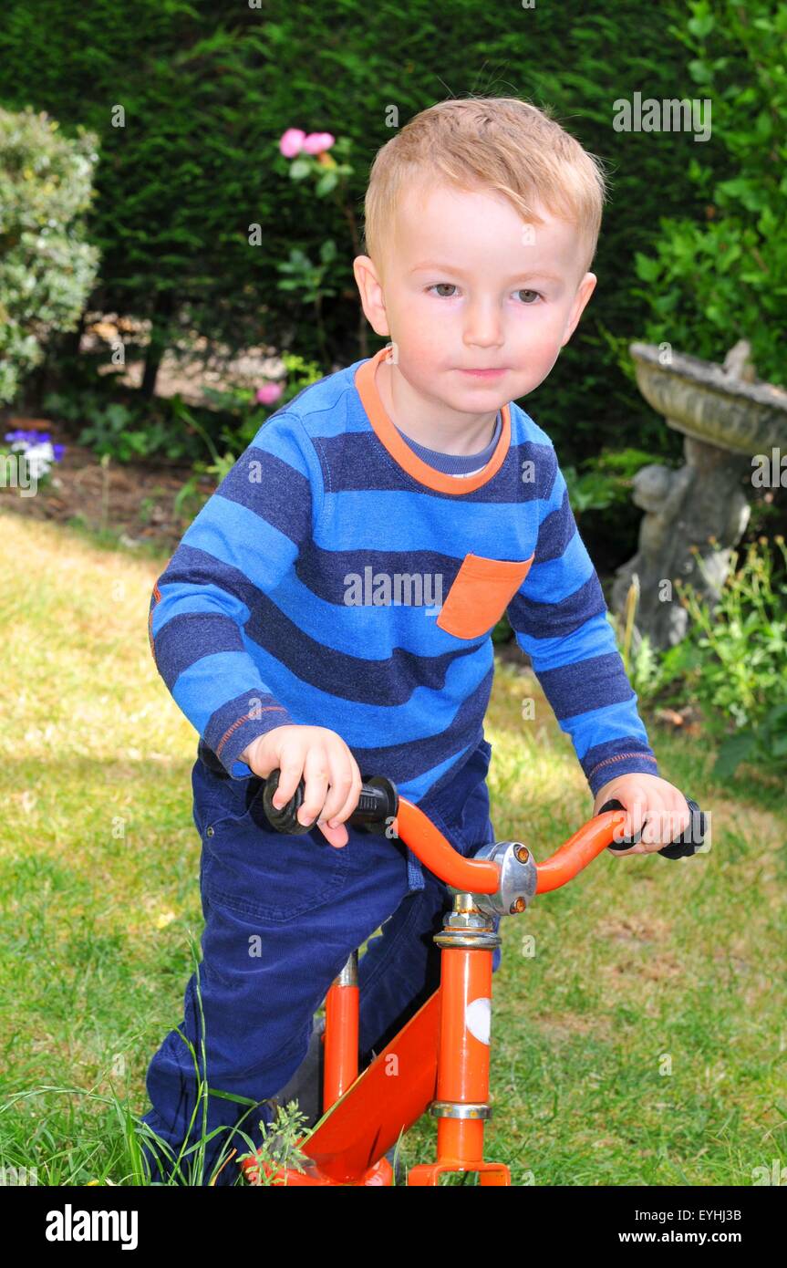 Happy child riding a bike Stock Photo - Alamy