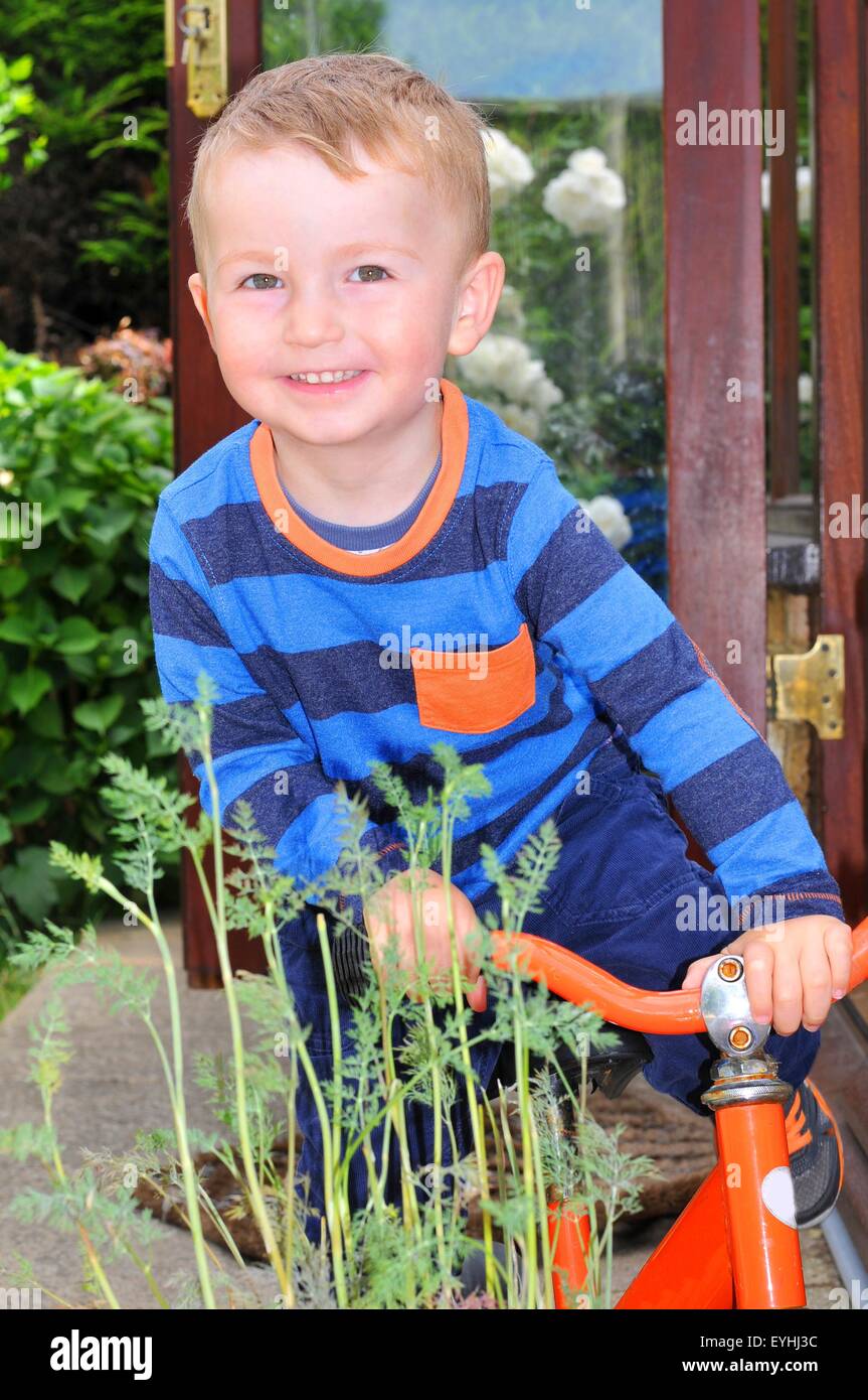 Happy child riding a bike Stock Photo - Alamy