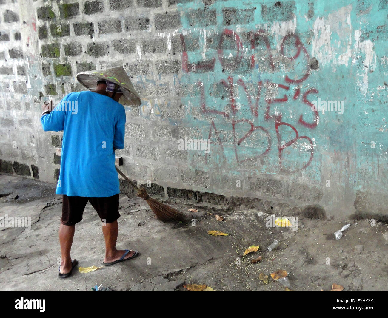 Navotas City, Philippines. 30th July, 2015. A Filipino sweeps next to a ...