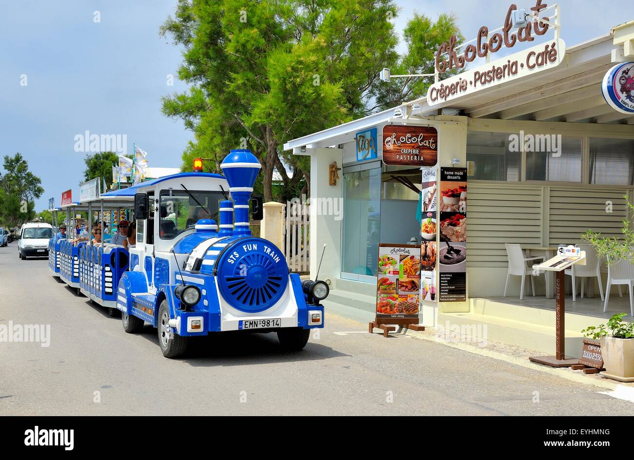 A tourist road train passing through Perissa,Santorini,Greece Stock ...