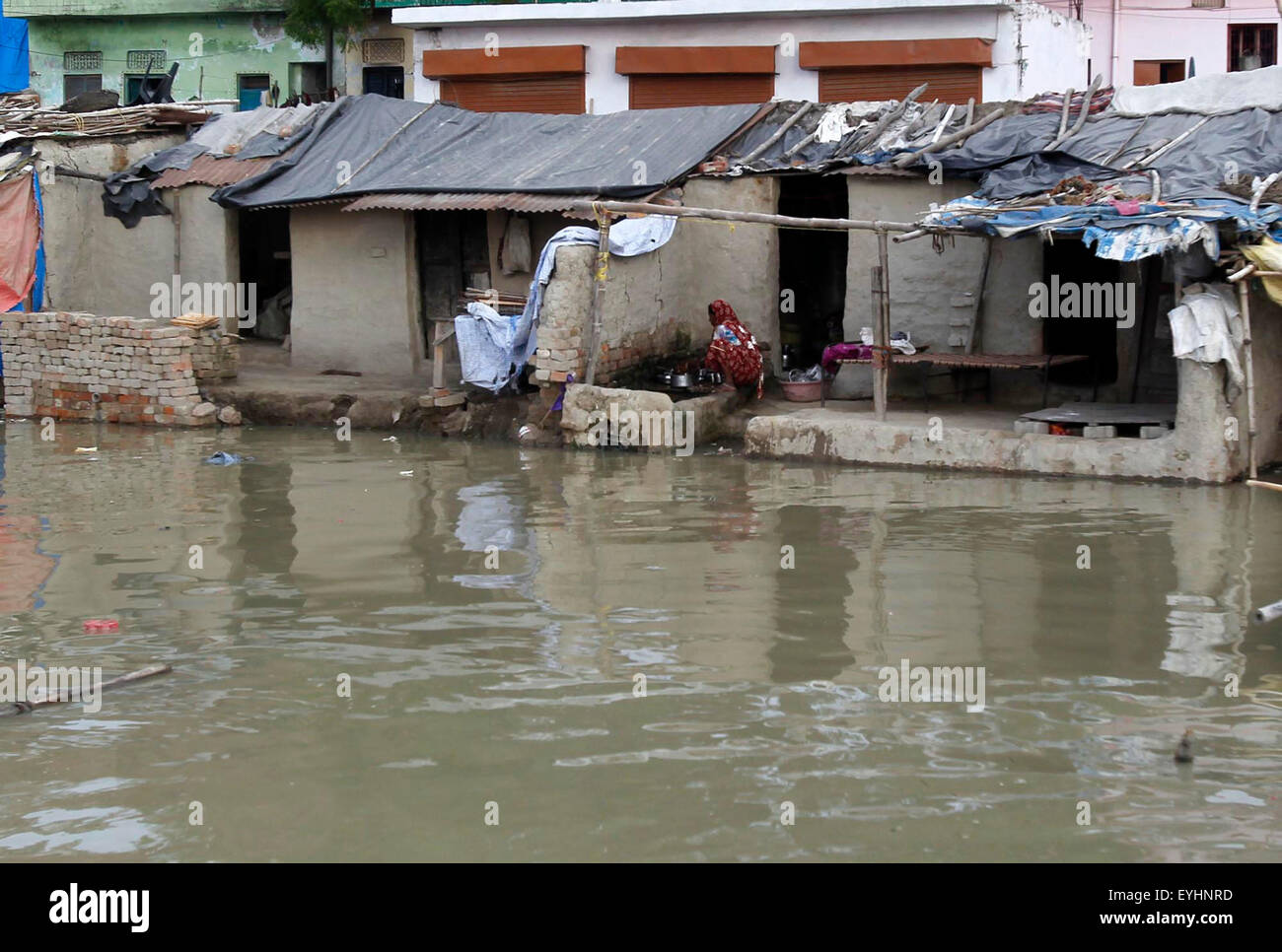 Allahabad, India. 30th July, 2015. A woman watching the flood water ...