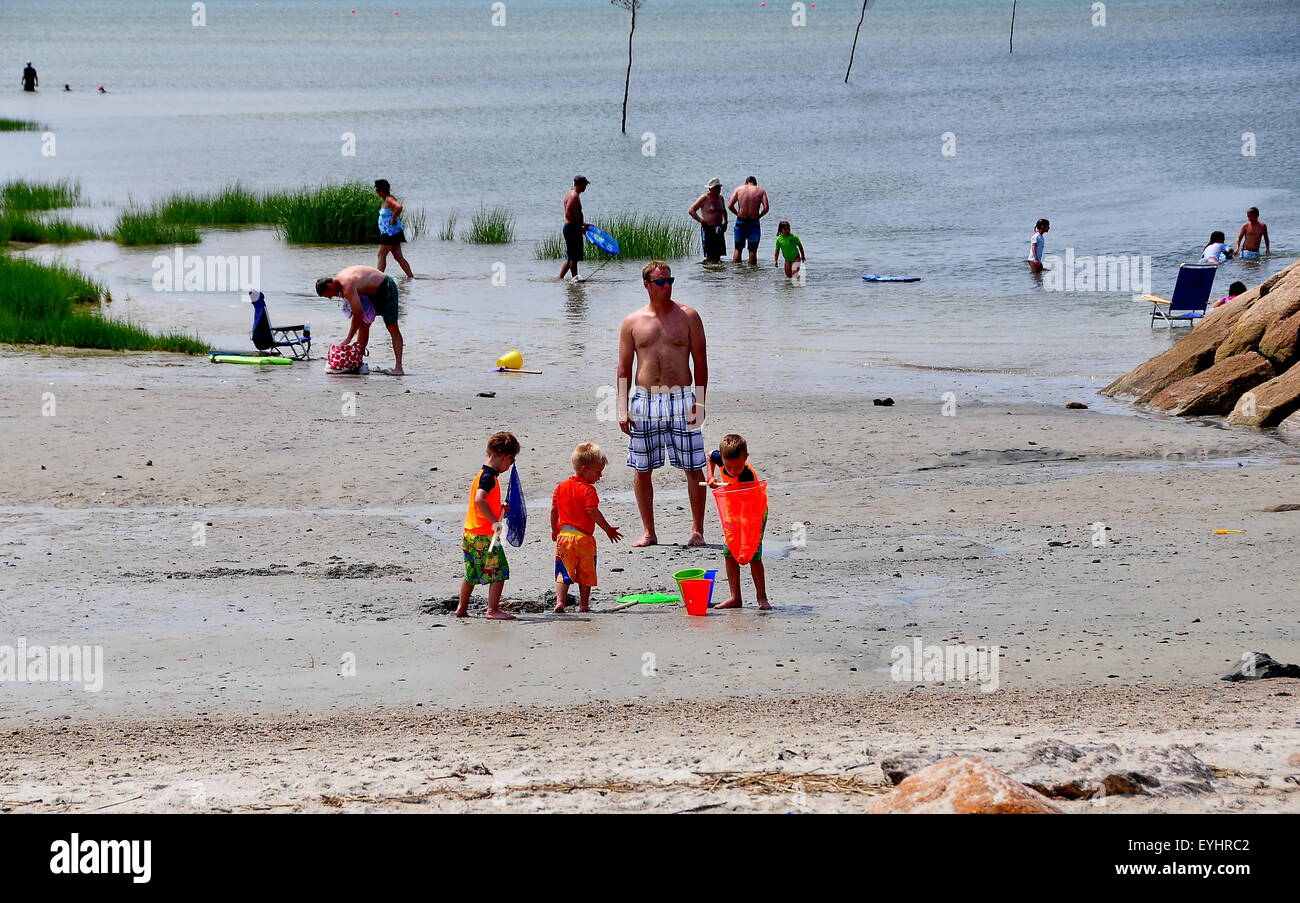 Orleans, Massachusetts: Three little boys playing on the beach watched ...