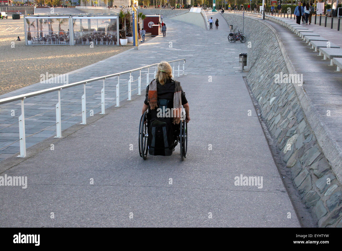 Woman in a wheelchair on a beach access ramp Stock Photo - Alamy