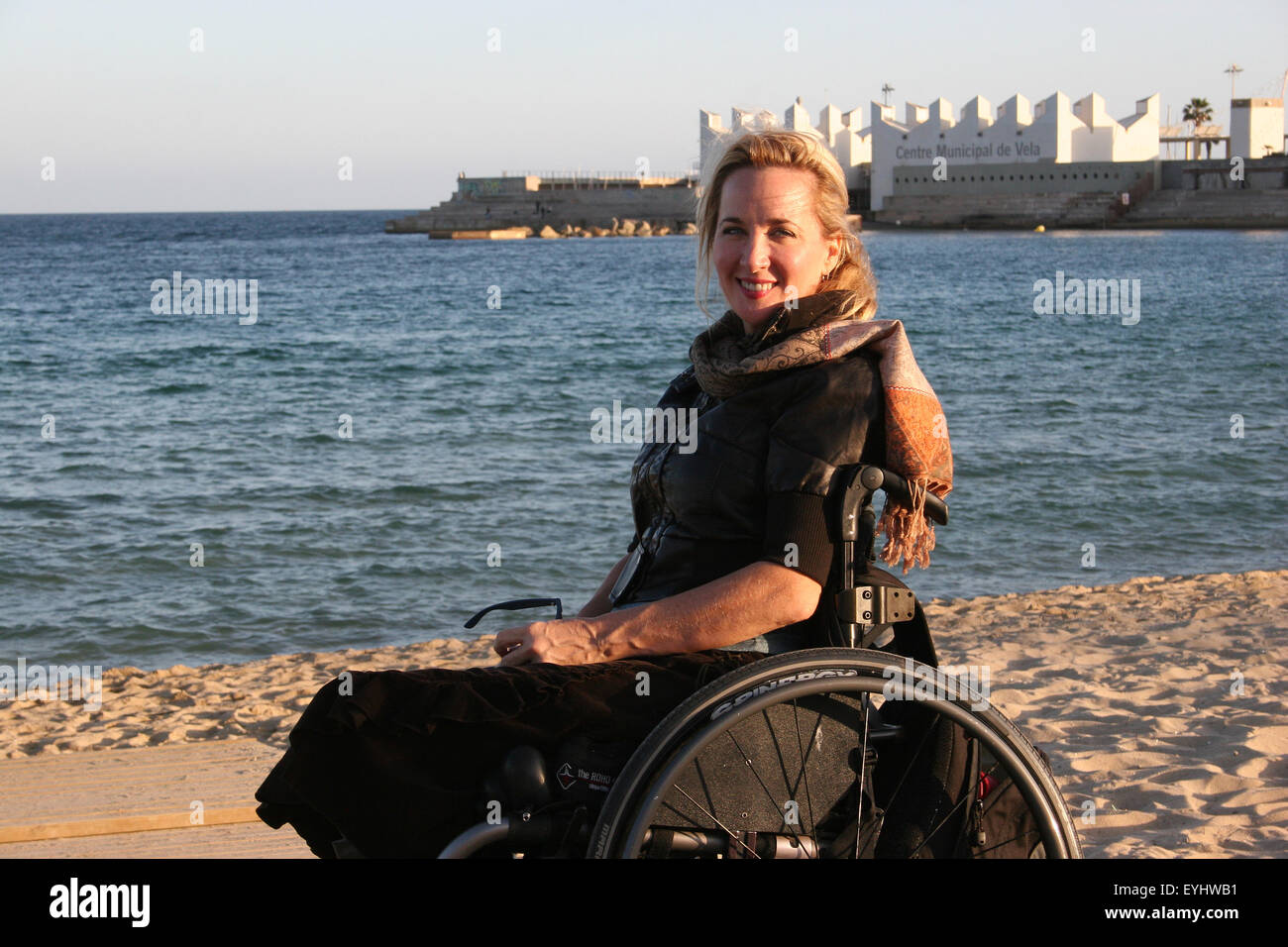 Woman using a wheelchair on a beach Stock Photo - Alamy