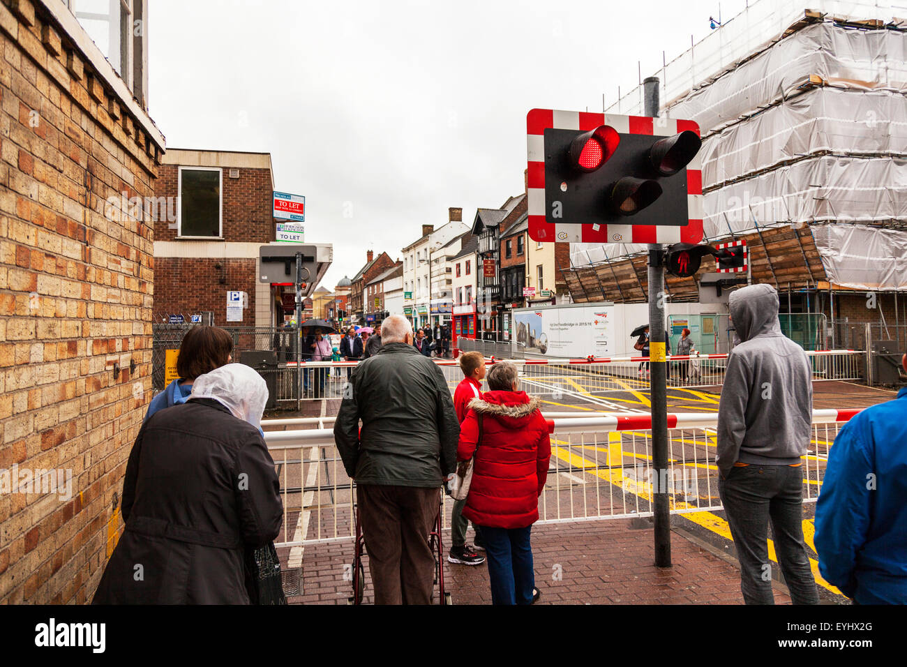 Level crossing flashing red lights people waiting stop danger do not ...