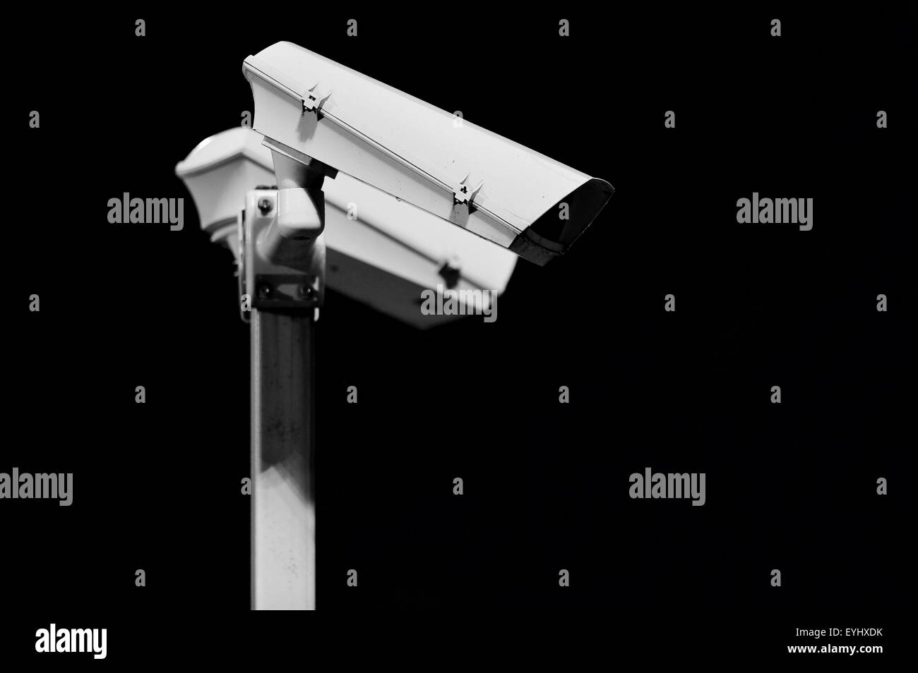 Two surveillance cameras isolated on black background Stock Photo - Alamy
