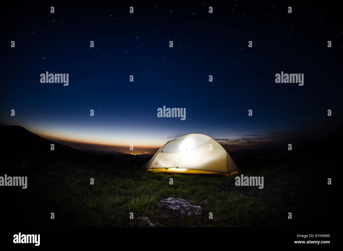 A tent lit against a starry night sky Stock Photo - Alamy