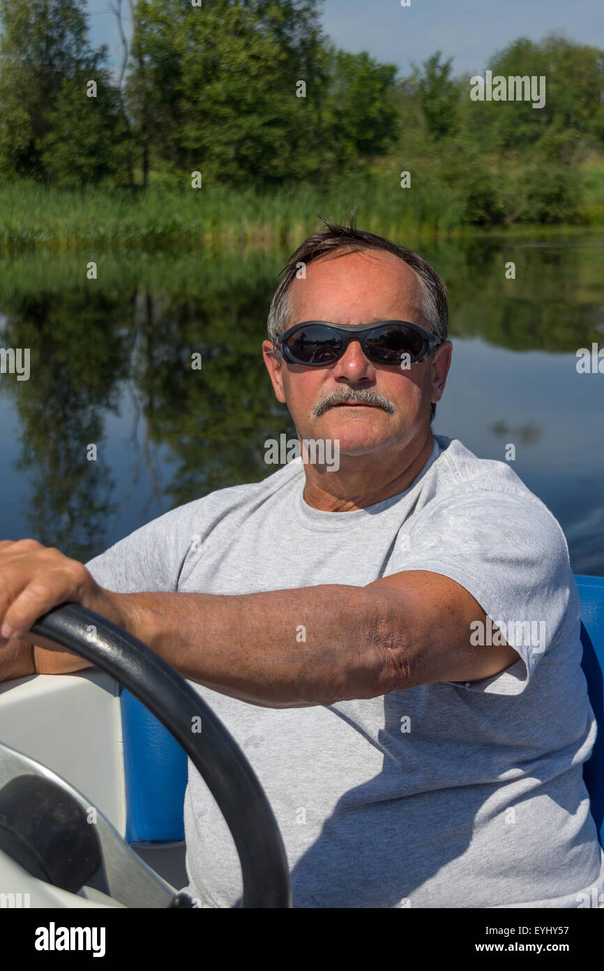 Person driving boat hi-res stock photography and images - Alamy
