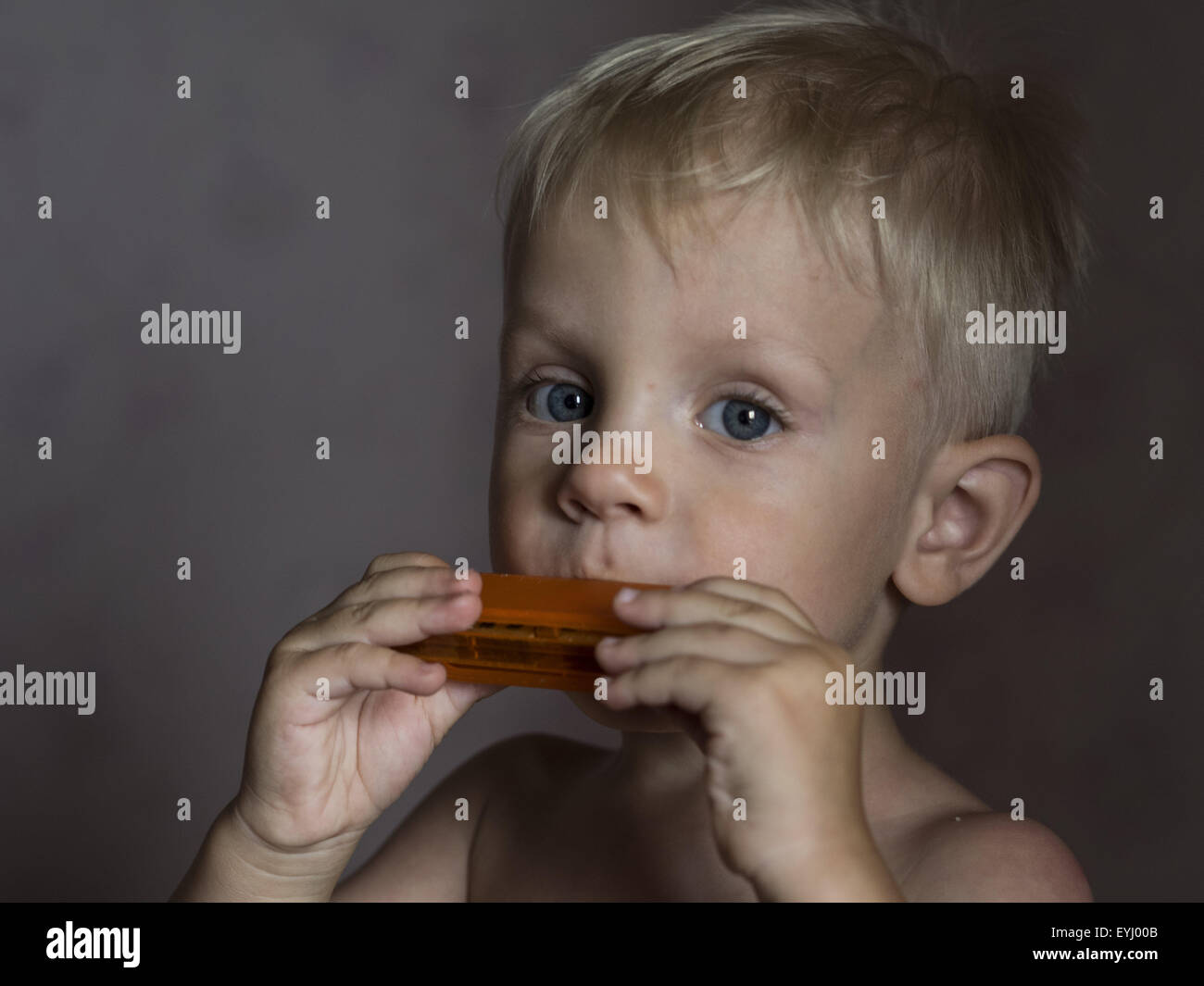 Boy playing harmonica hi-res stock photography and images - Alamy