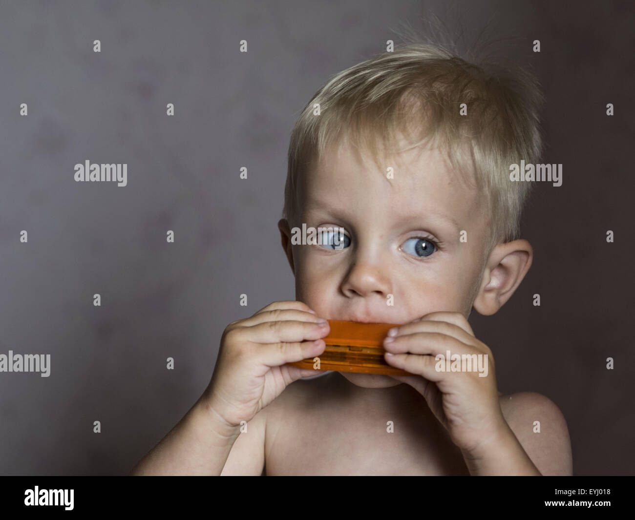 Boy playing harmonica hi-res stock photography and images - Alamy