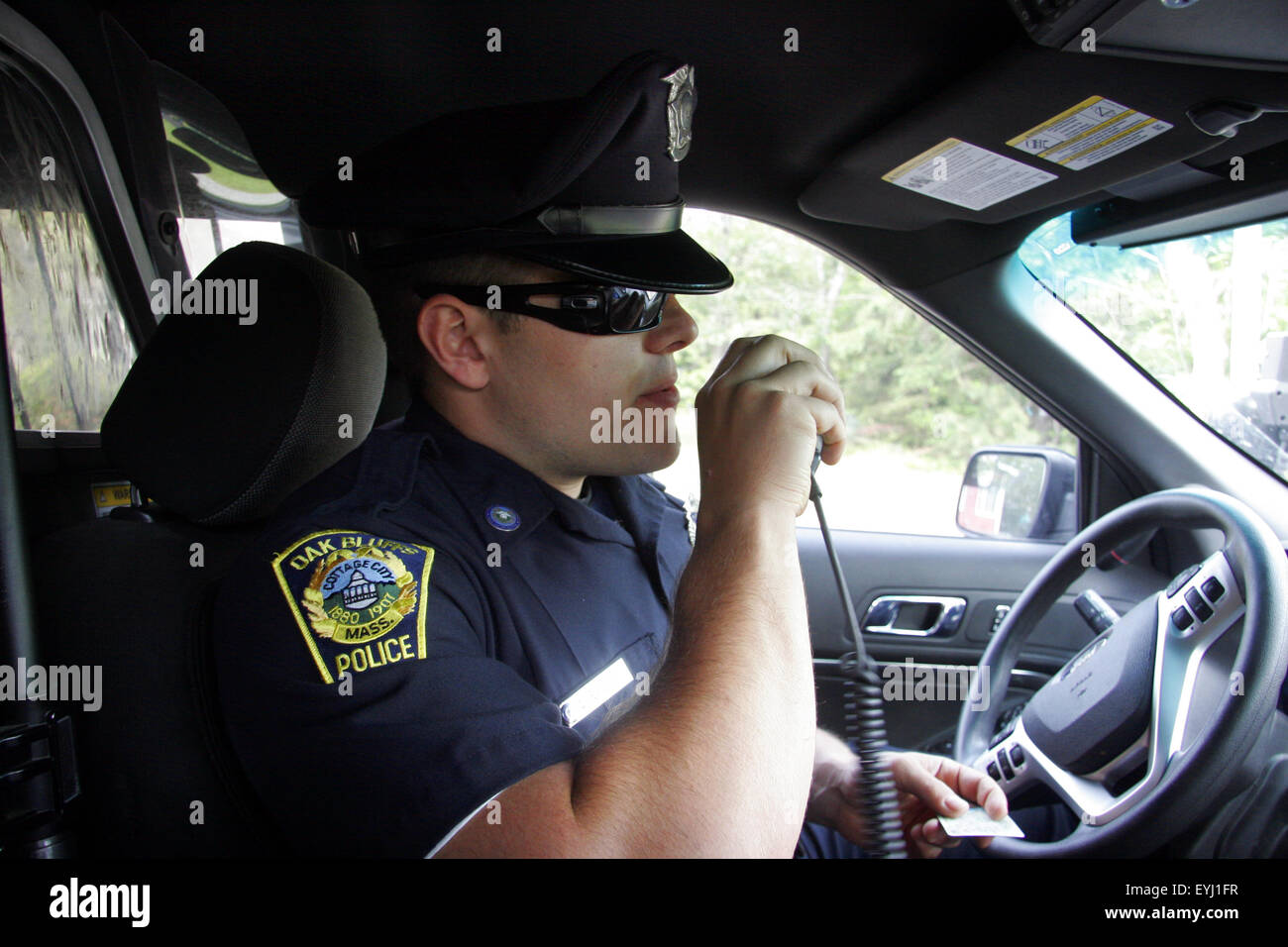Police officer speaking on a police radio, Oak Bluffs, Massachusetts ...