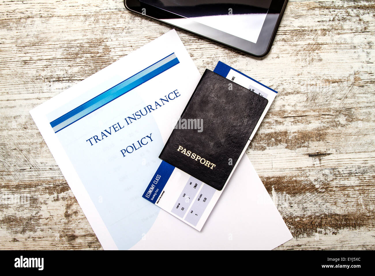 Travel insurance policy booklet with a boarding pass and a passport ...