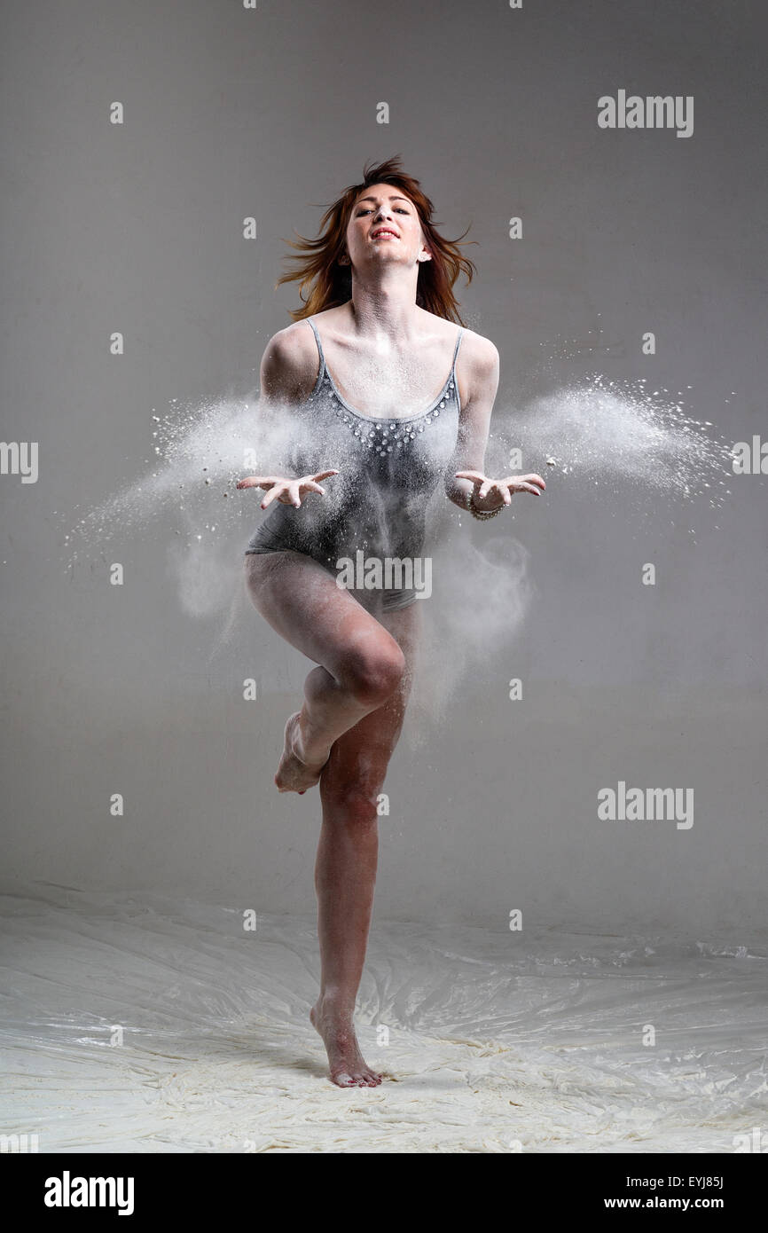 Beautiful expressive ballet dancer posing with flour at studio Stock Photo - Alamy