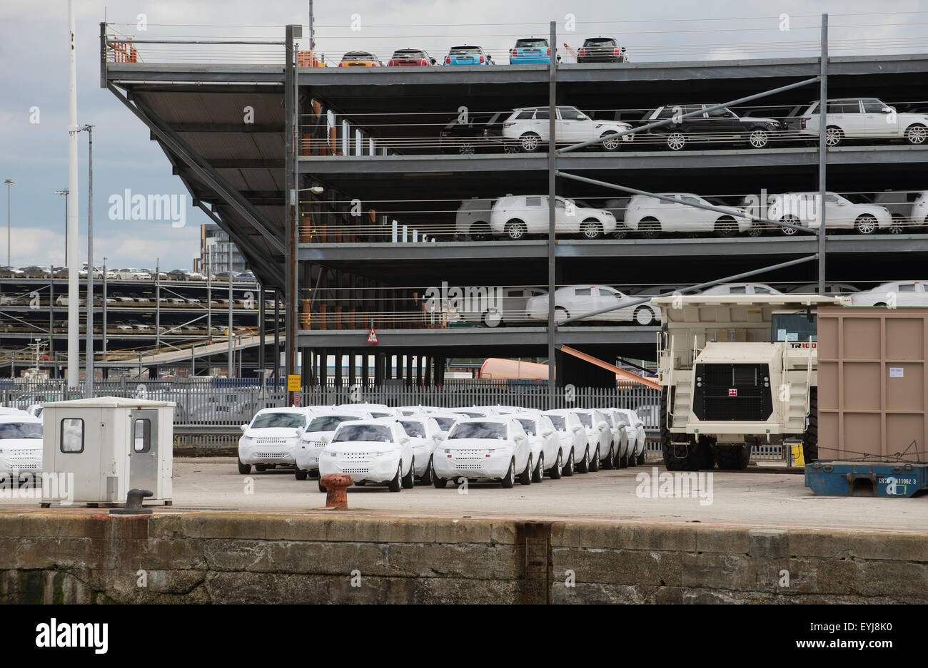 Luxury cars wrapped for protection for export from the UK on the docks ...