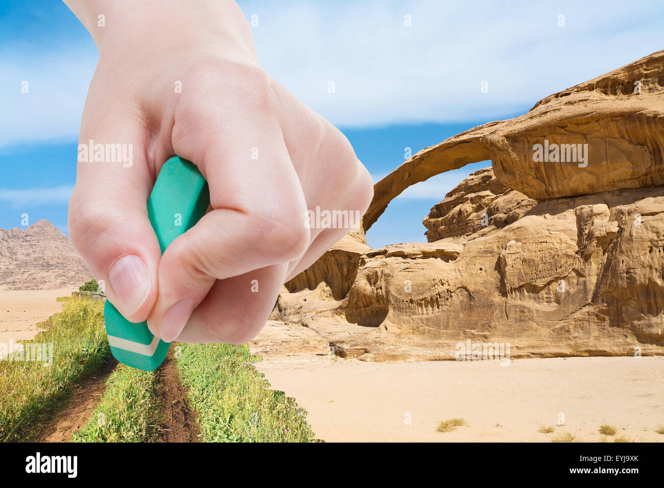weather concept - hand deletes sand in desert by rubber eraser from ...