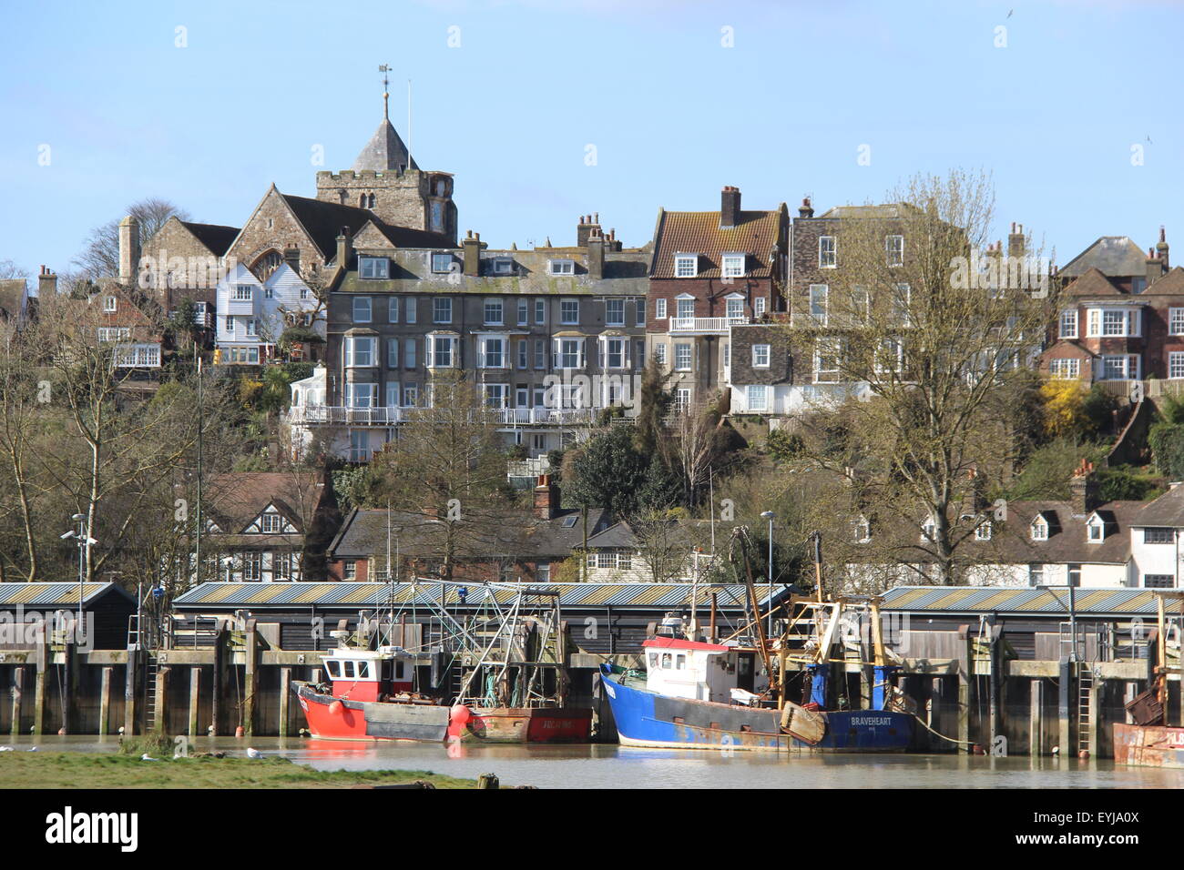 A sunny landscape view of fishing boats and river in the town of Rye in ...