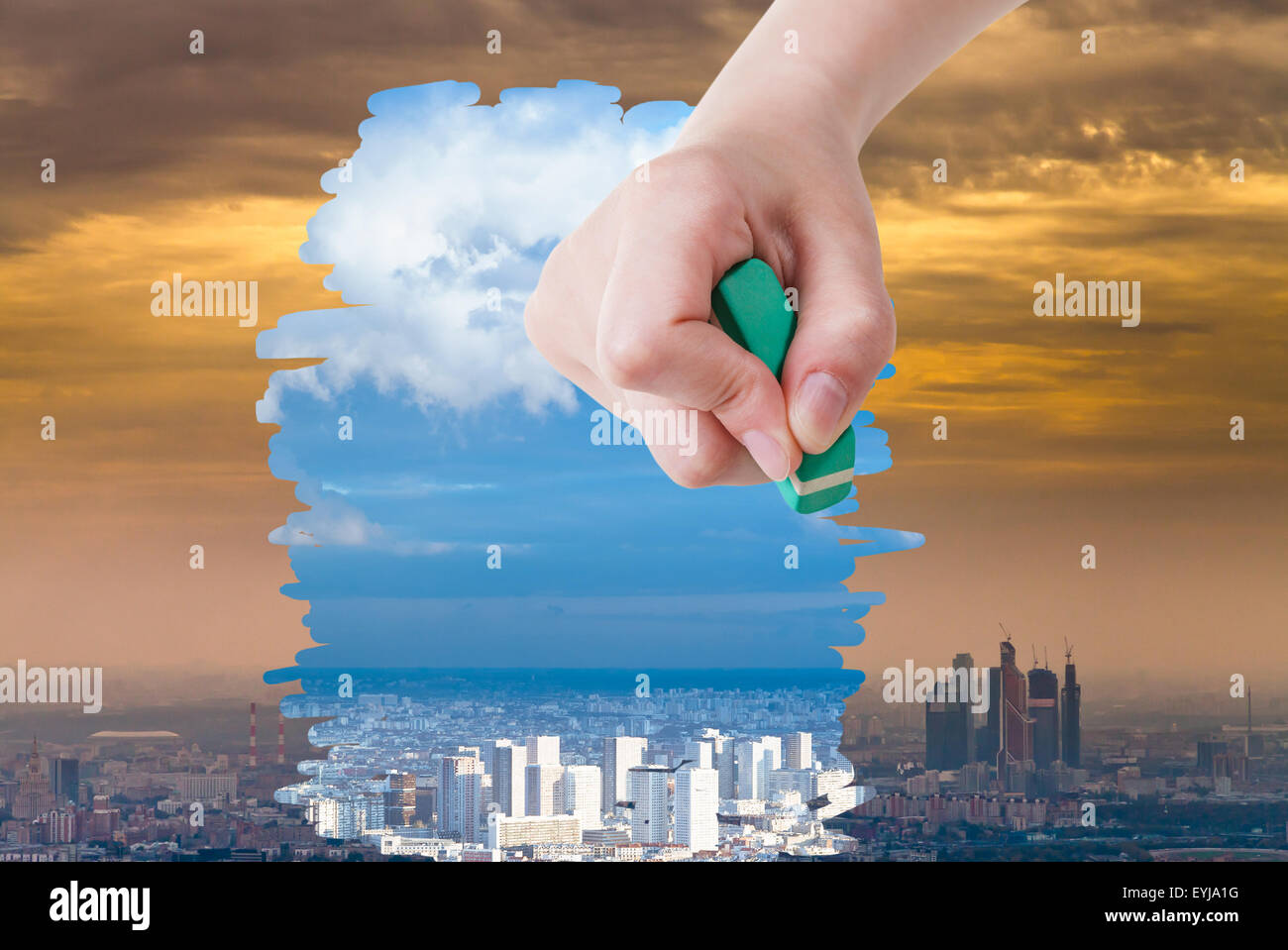 weather concept - hand deletes smog urban landscape by eraser from ...