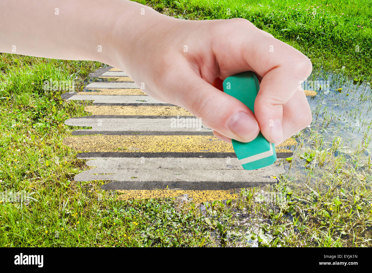 weather concept - hand deletes green swamp by rubber eraser from image ...