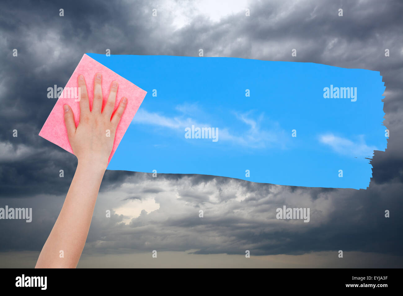weather concept - hand deletes storm clouds by pink cloth from image ...