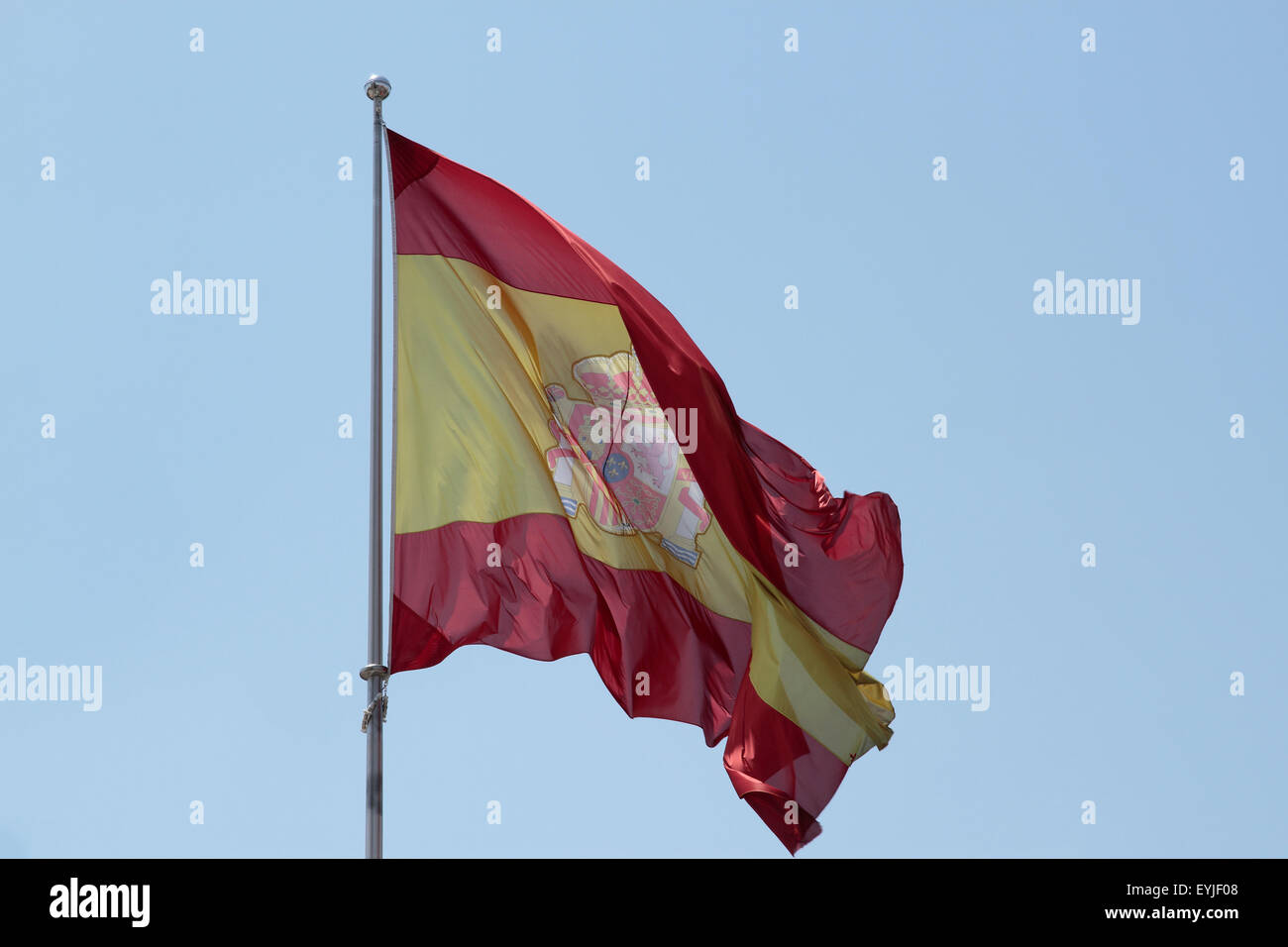 spanish flag flying over the blue sky Stock Photo - Alamy