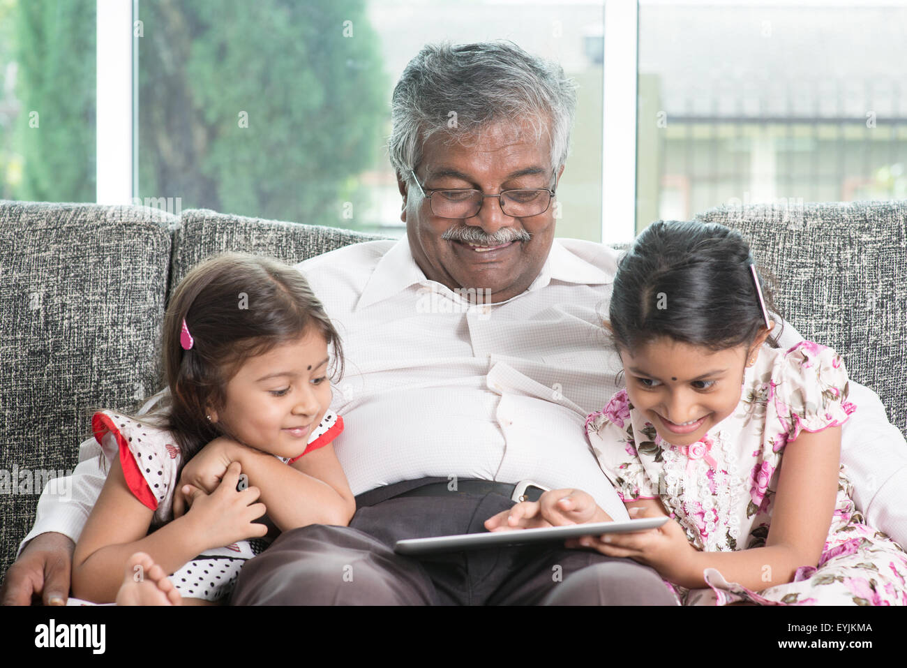 Modern technology concept. Grandparent and grandchildren using touch ...