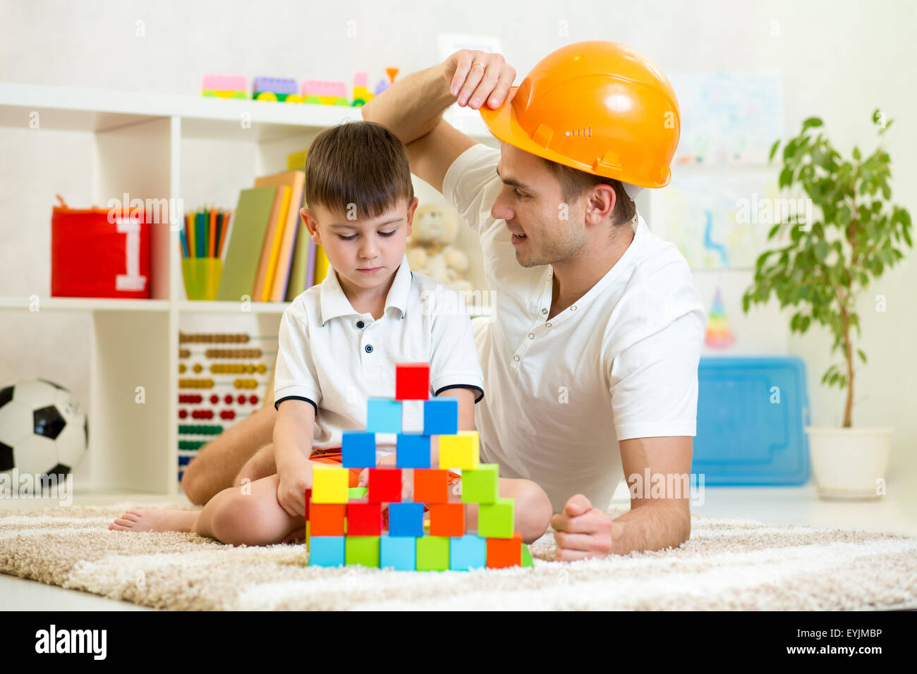 Father and child play construction game together at home Stock Photo ...