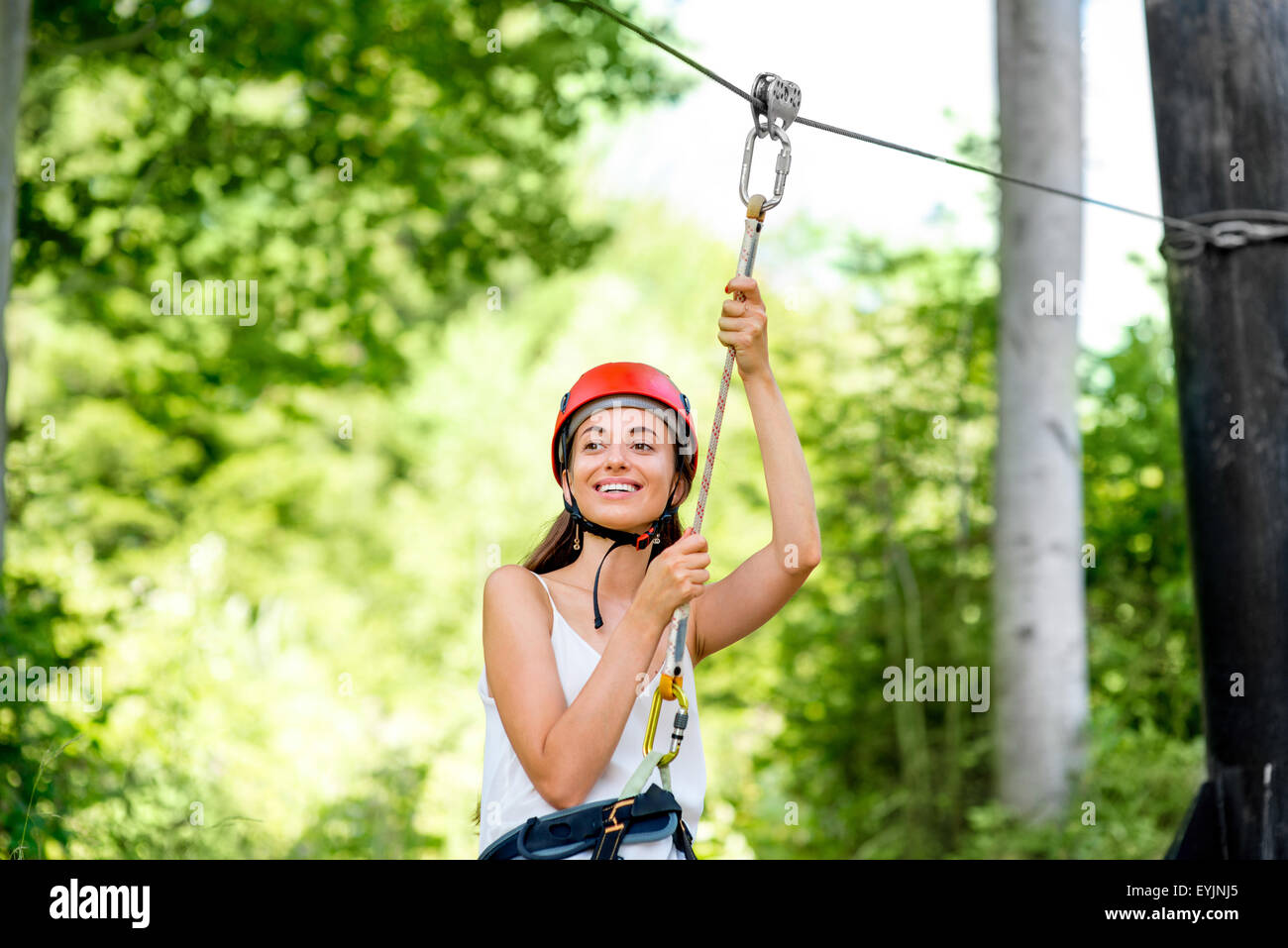 Woman riding on a zip line Stock Photo - Alamy