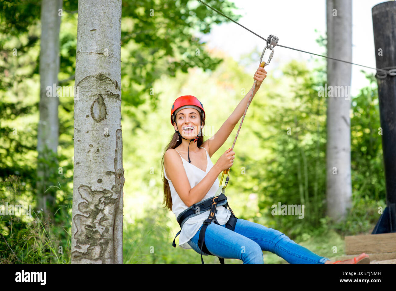 Woman riding on a zip line Stock Photo - Alamy