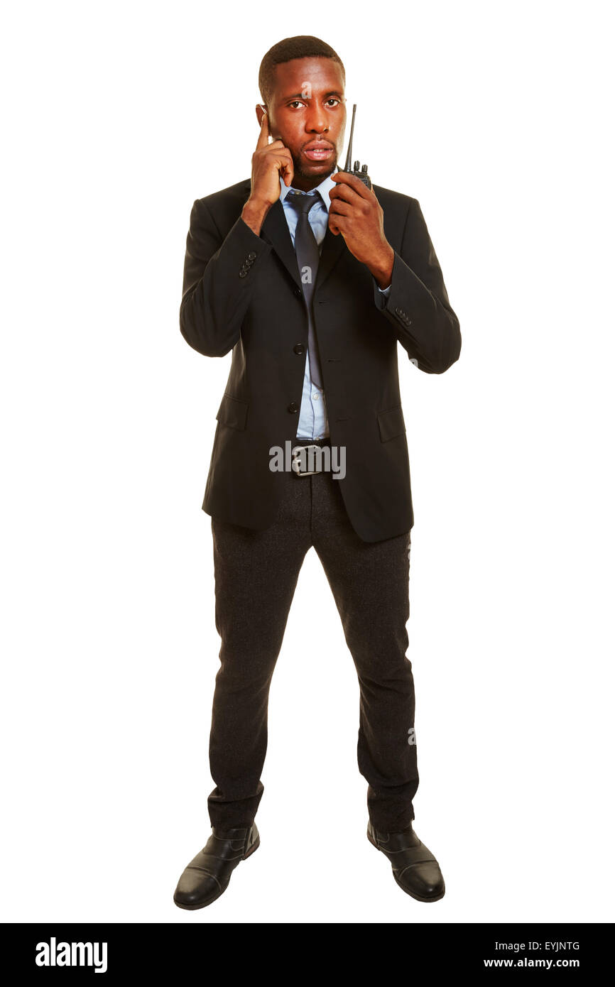 African bodyguard from personal security in a suit with a radio set ...