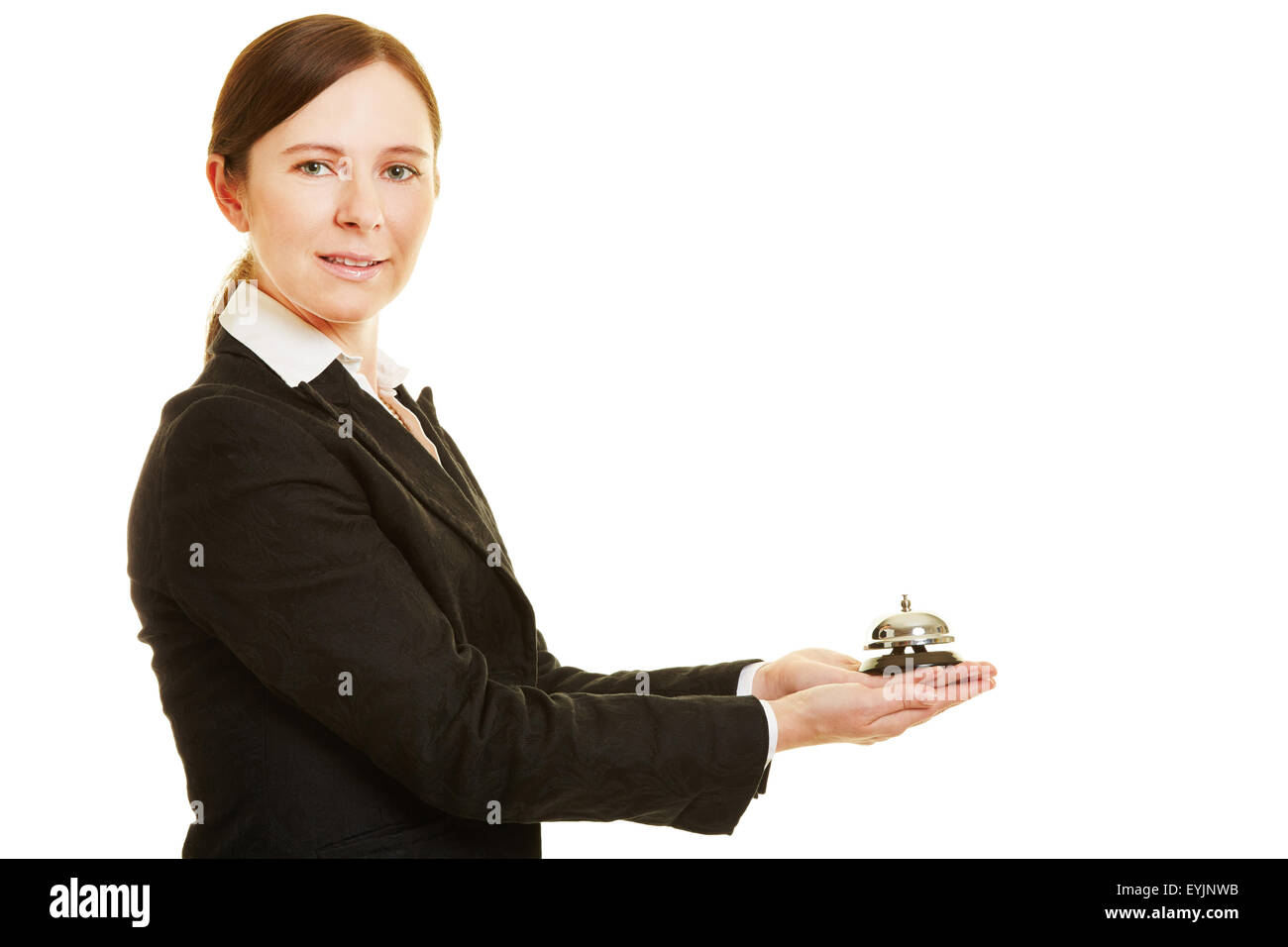 Female concierge holding a hotel bell in her hands Stock Photo - Alamy
