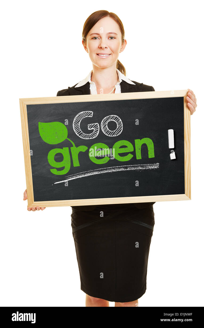 Business woman holding "go green" concept on a blackboard in her hands ...