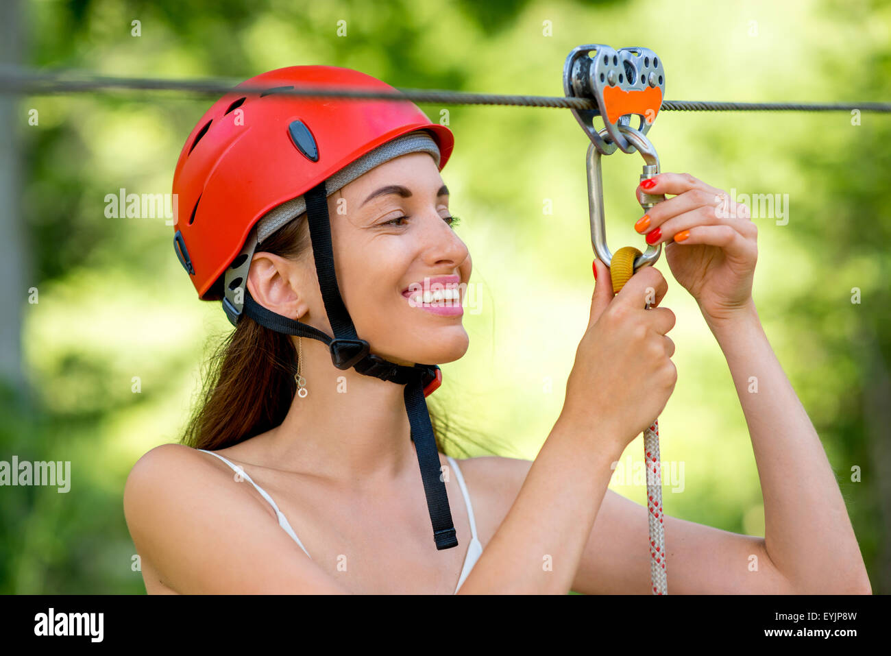Woman riding on a zip line Stock Photo - Alamy
