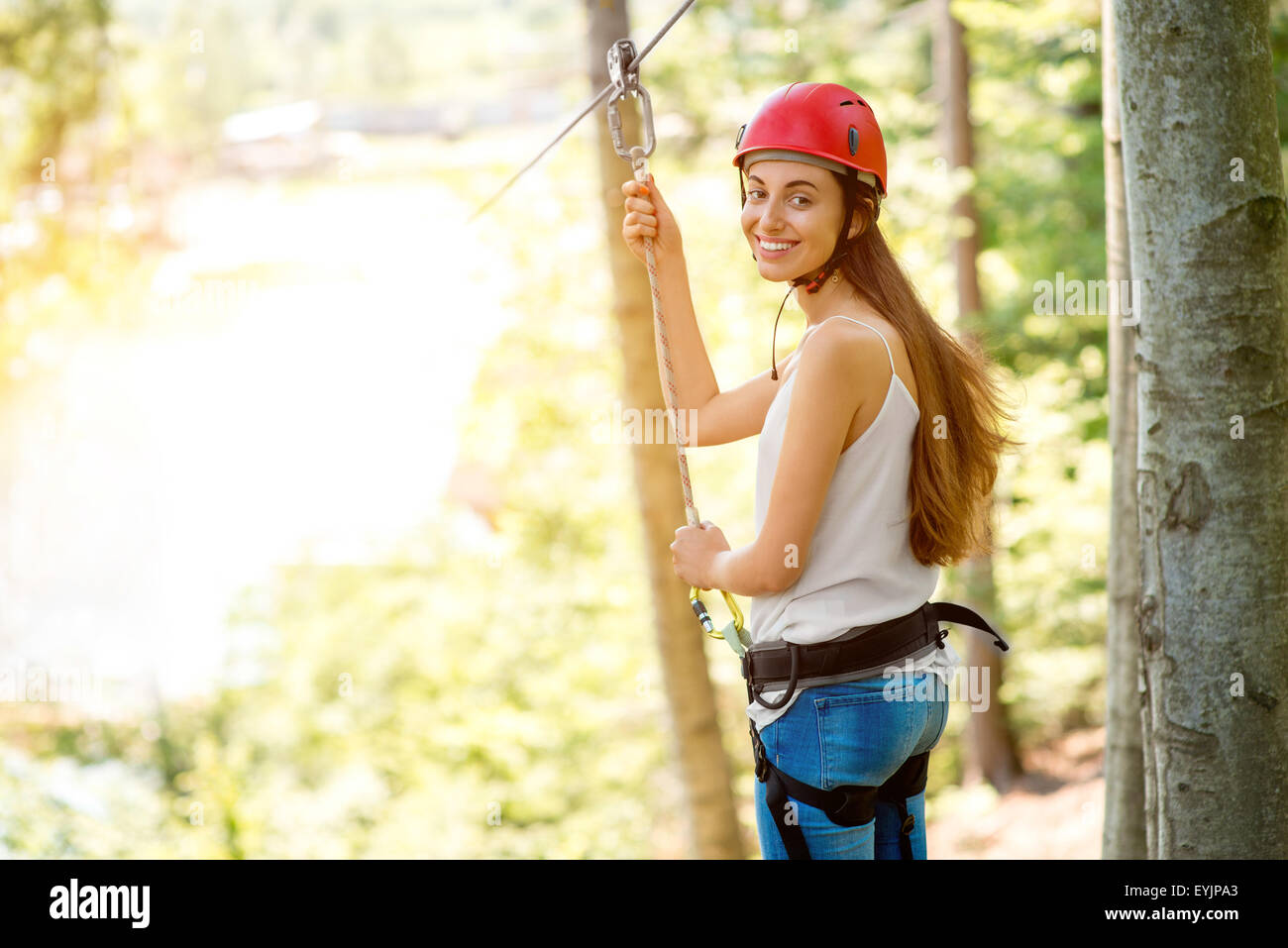 Woman riding on a zip line Stock Photo - Alamy