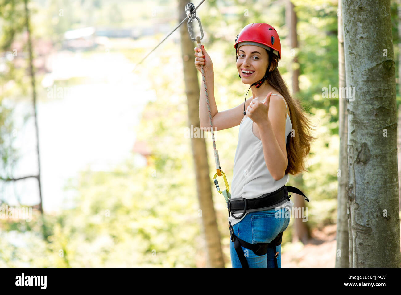 Woman riding on a zip line Stock Photo - Alamy