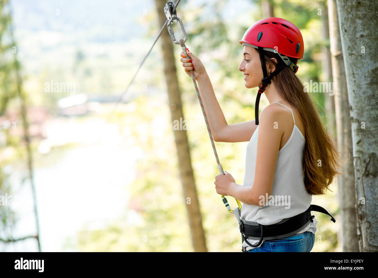 Woman riding on a zip line Stock Photo - Alamy