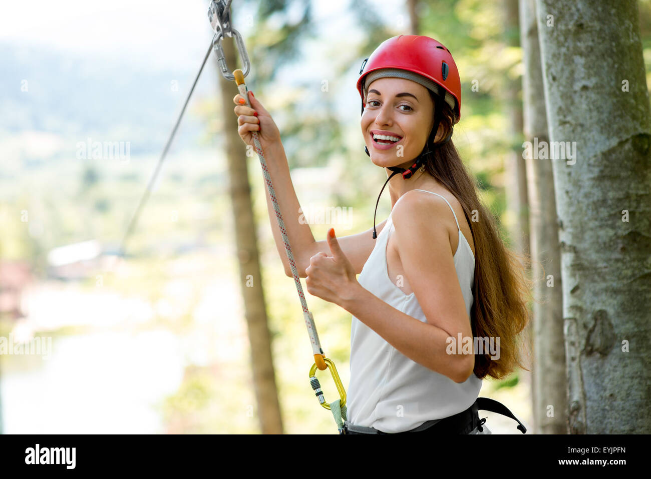 Woman riding on a zip line Stock Photo - Alamy