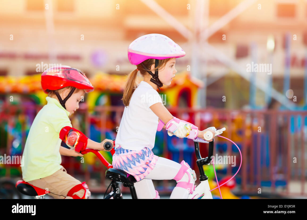 Happy children racing on bicycles, brother and sister organized sports ...