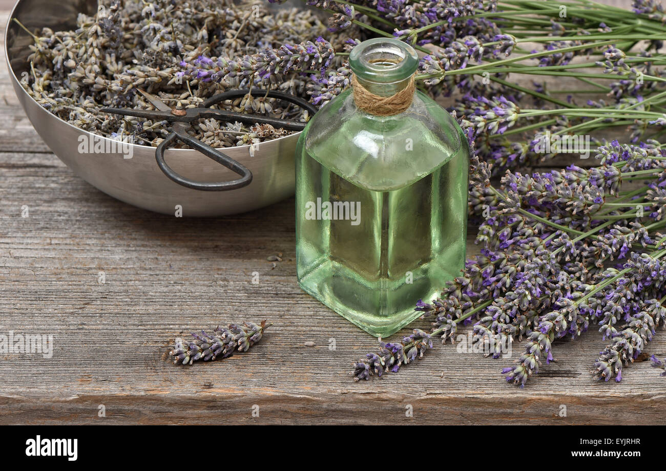 Lavender oil with fresh flowers on wooden background. Vintage style ...