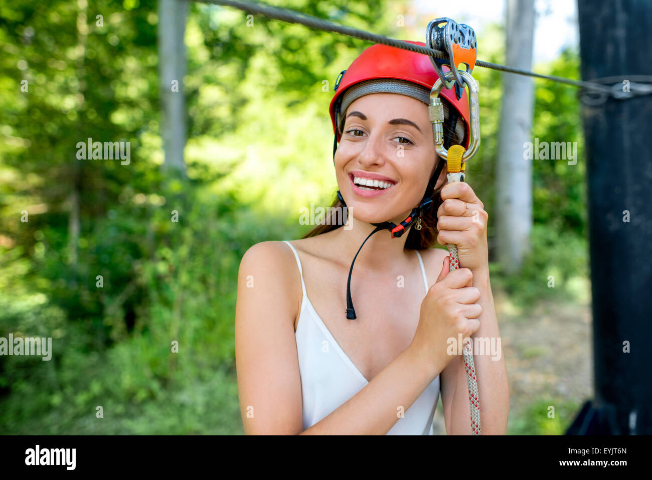 Woman riding on a zip line Stock Photo - Alamy