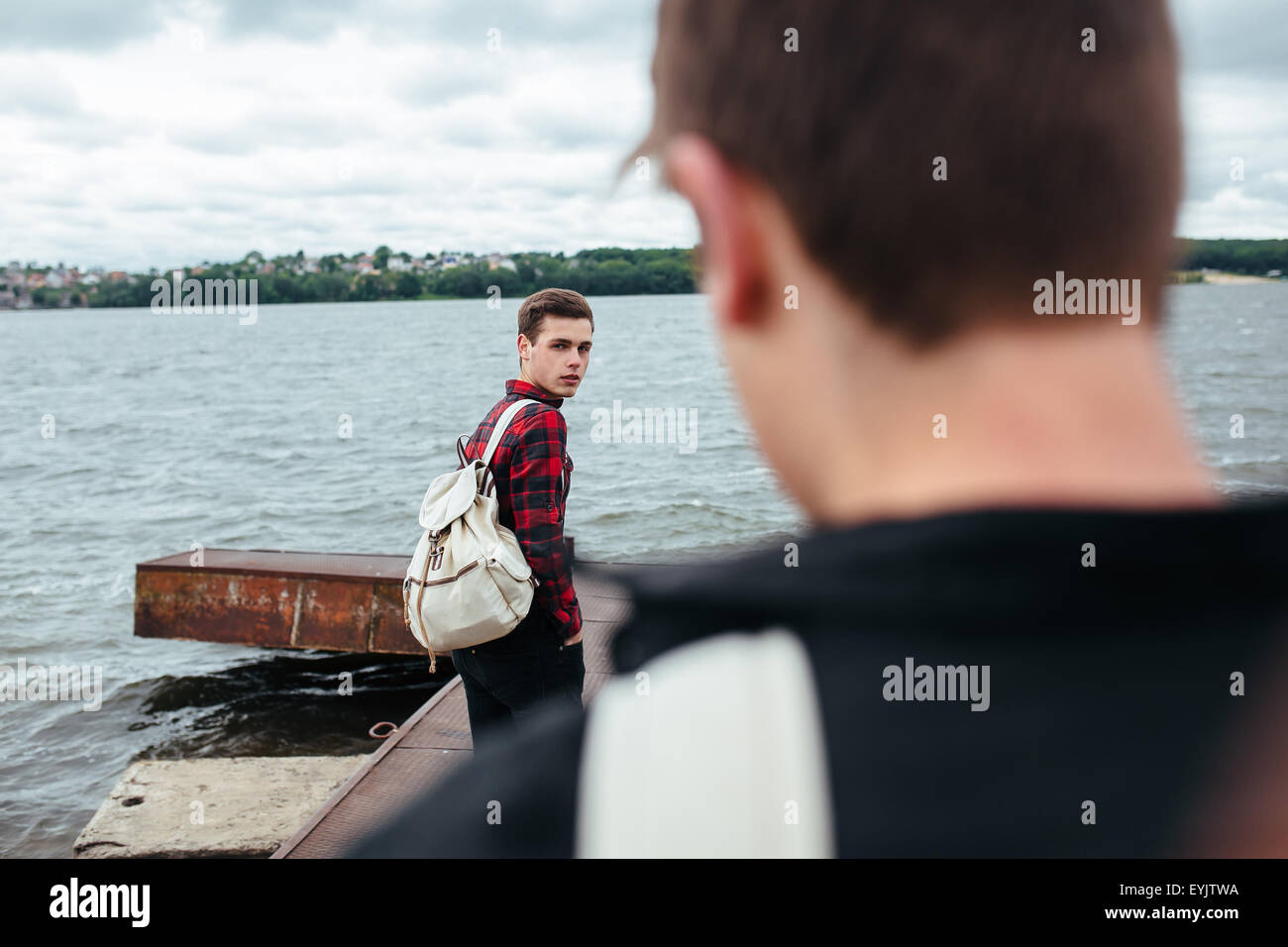 two young guys standing on a pier Stock Photo - Alamy