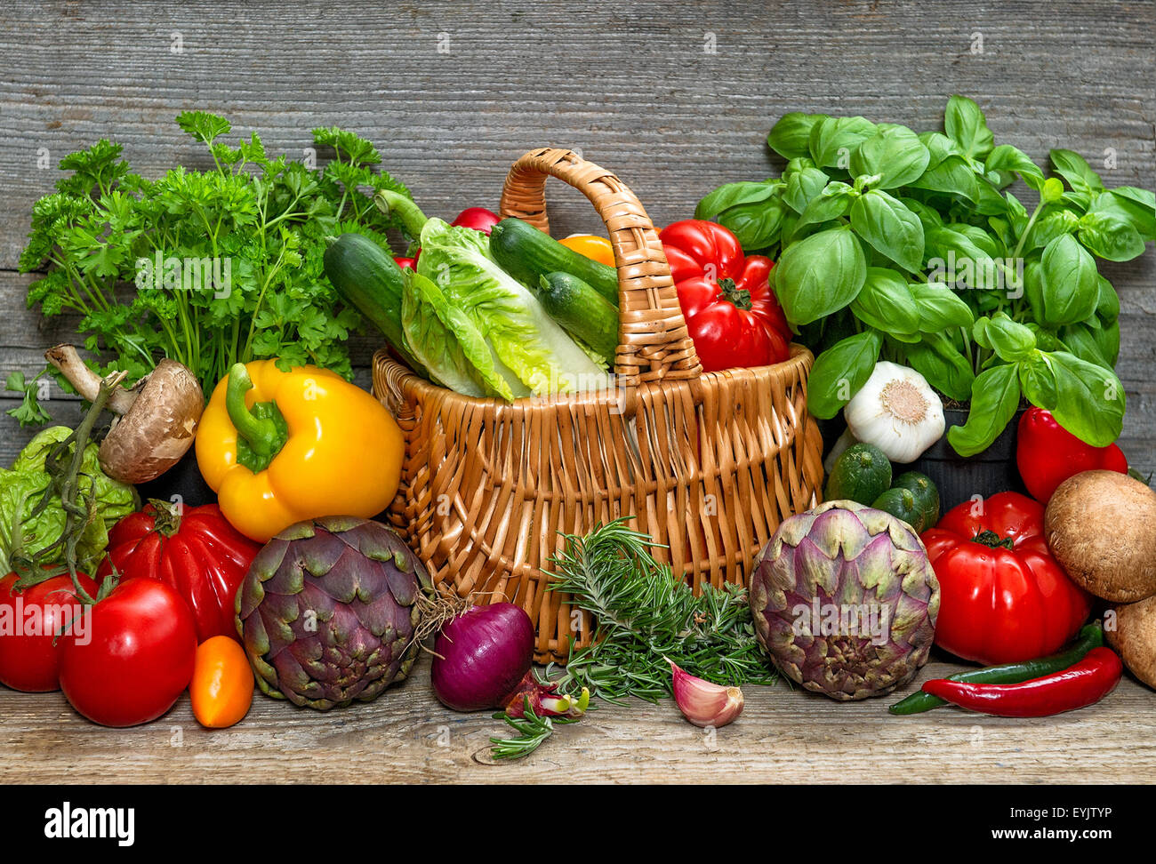 Vegetables and herbs on wooden background. Fresh food ingredients ...