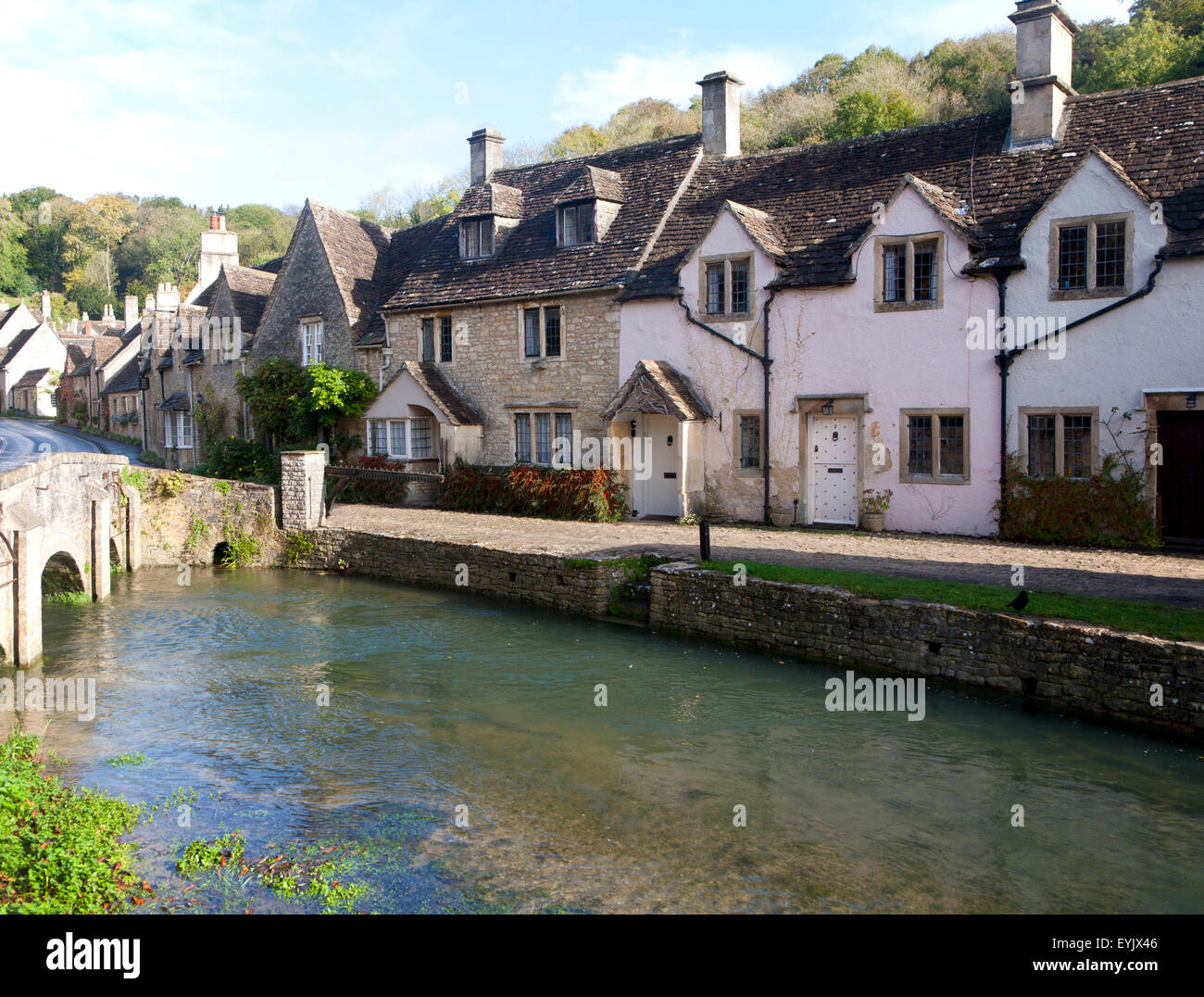 Bybrook River running past stone cottages in Castle Combe, Wiltshire ...